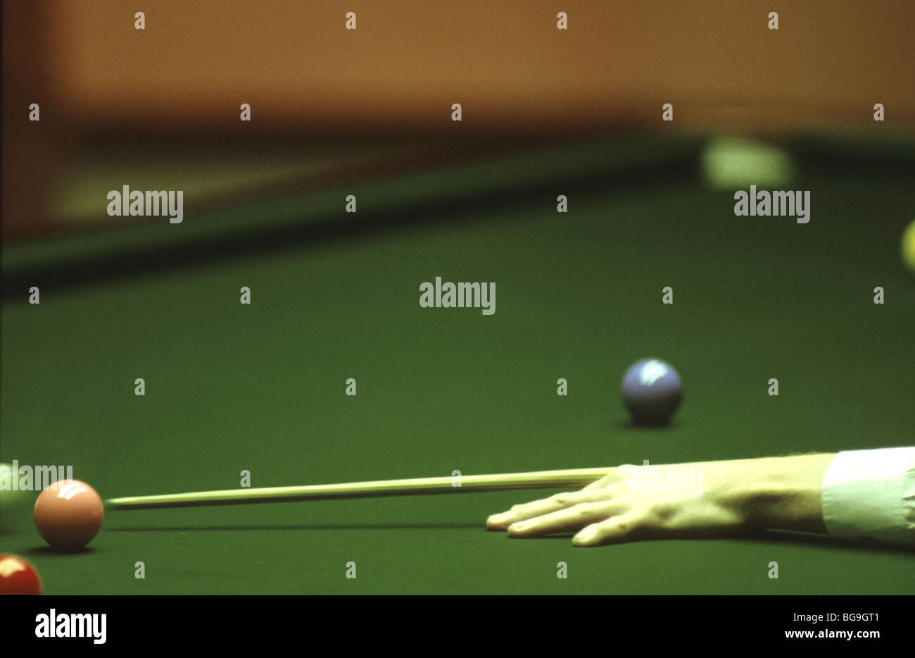 Man playing snooker with hand on flat table Stock Photo - Alamy