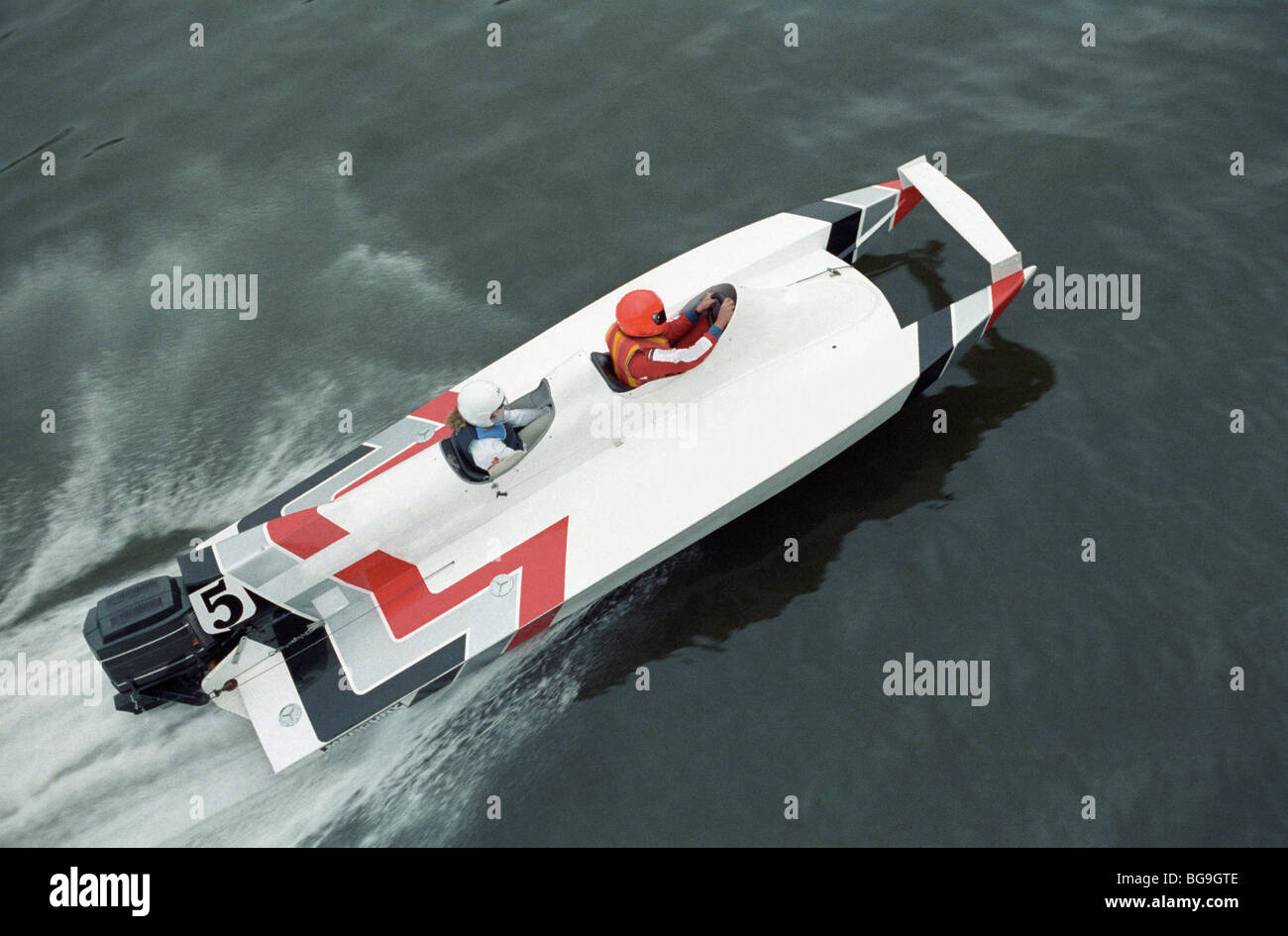 Multi Hull Powerboat drives through still water in race Stock Photo - Alamy