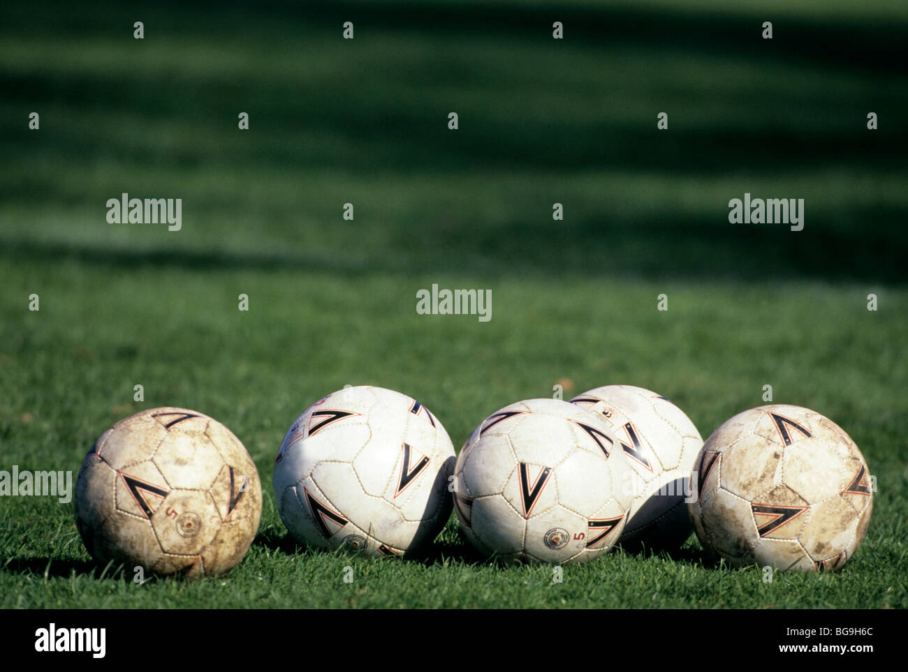 Footballs on a pitch Stock Photo - Alamy