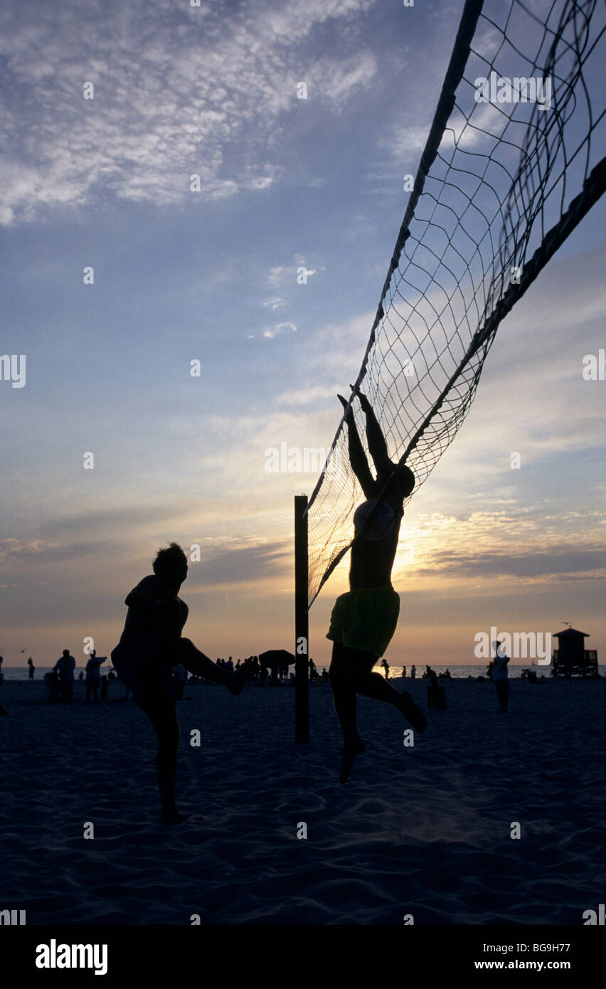 Beach volleyball match at sunset Stock Photo - Alamy