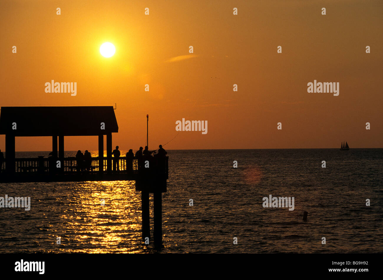 Silhouette of a group pier fishing Stock Photo - Alamy