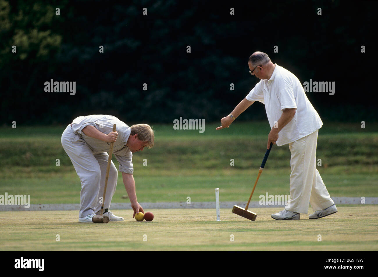 Two men playing croquet Stock Photo - Alamy