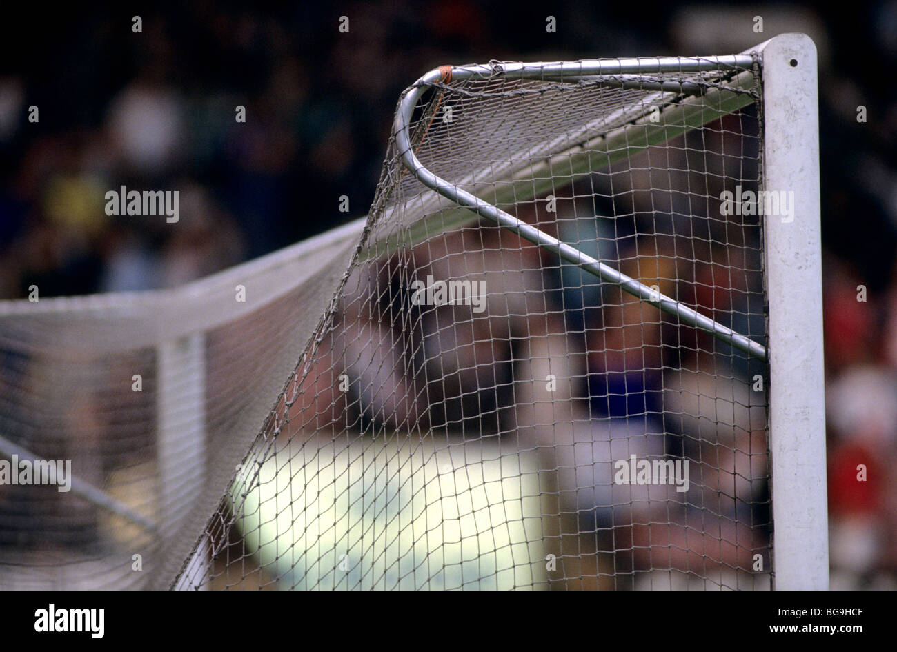 Goal net with football fans in background Stock Photo - Alamy