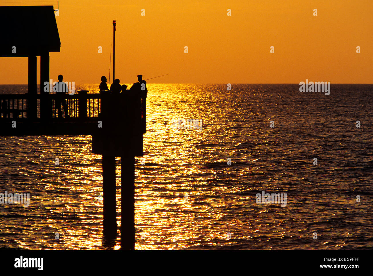 Silhouette of a group pier fishing Stock Photo - Alamy