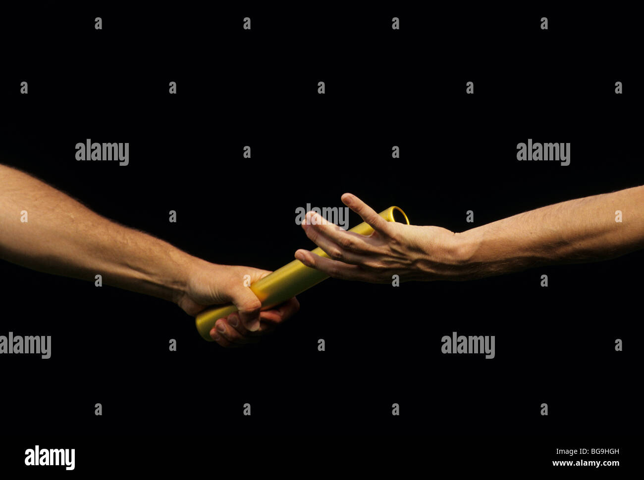 Two athletes passing a baton Stock Photo - Alamy