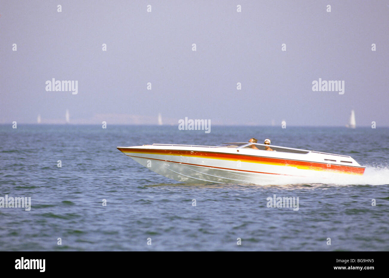 People on a speed boat speeding across the sea Stock Photo - Alamy