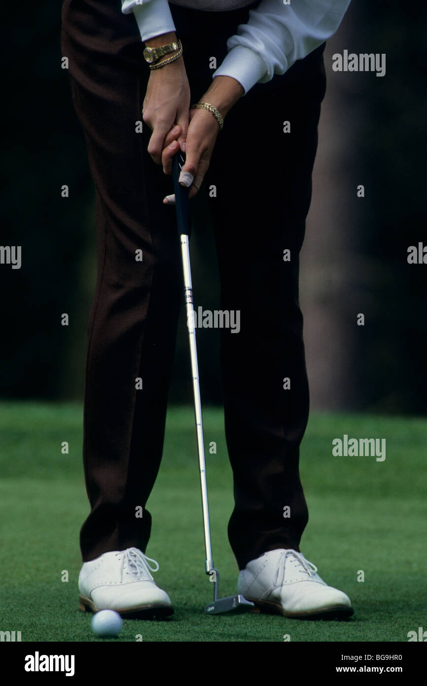 Golfer putting a ball Stock Photo - Alamy