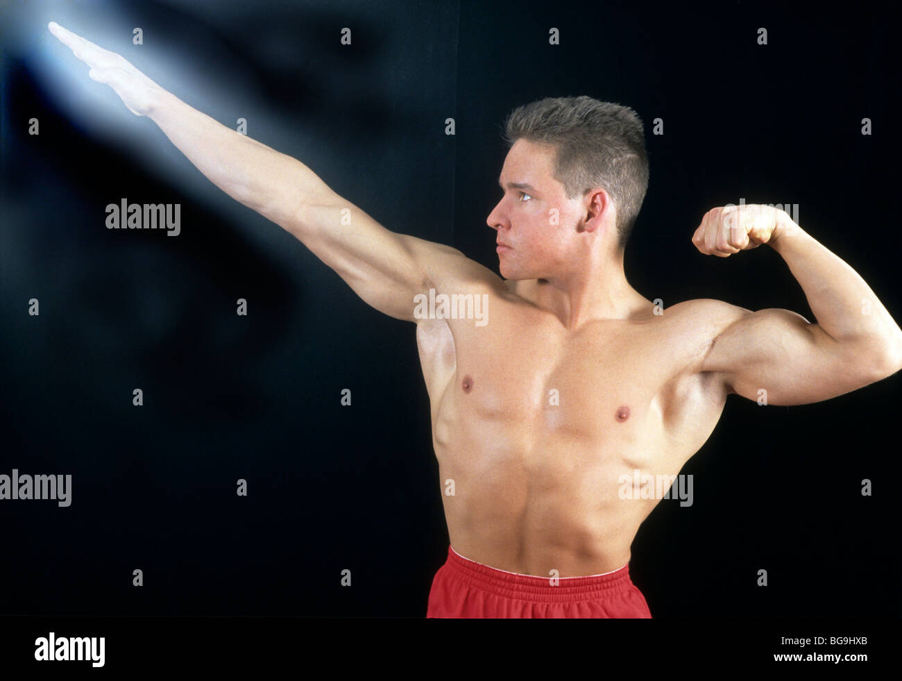 Body builder posing to show muscle definition Stock Photo - Alamy
