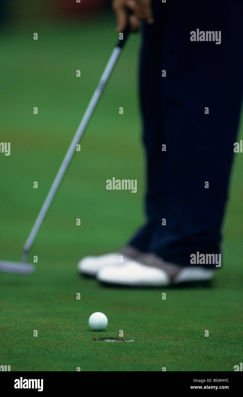 Golfer putting a ball Stock Photo - Alamy