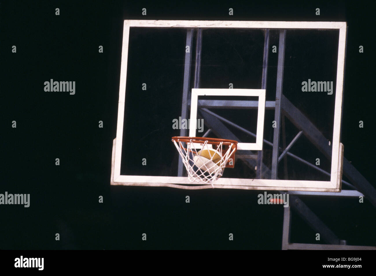 Basketball going through a hoop Stock Photo - Alamy