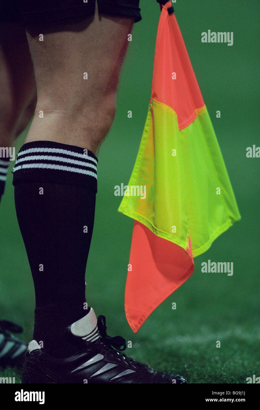 Football referee holding a flag Stock Photo - Alamy