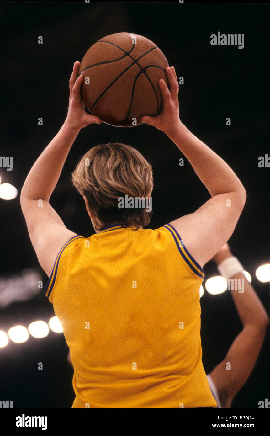 Basketball player holding ball above his head during a game Stock Photo ...