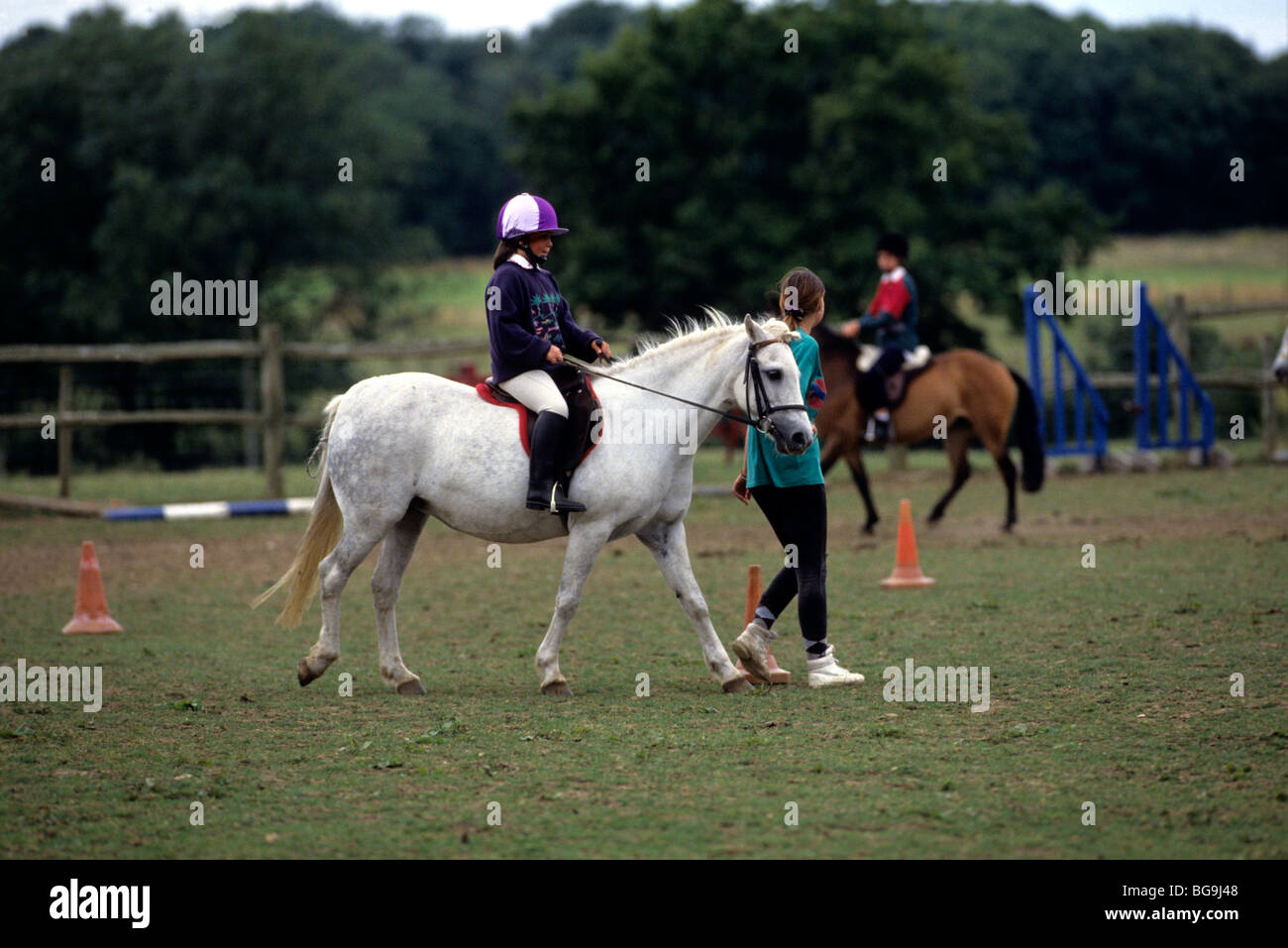 Horse riders in a riding school Stock Photo - Alamy