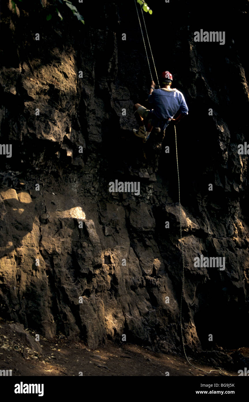 Man abseiling a rock face Stock Photo - Alamy