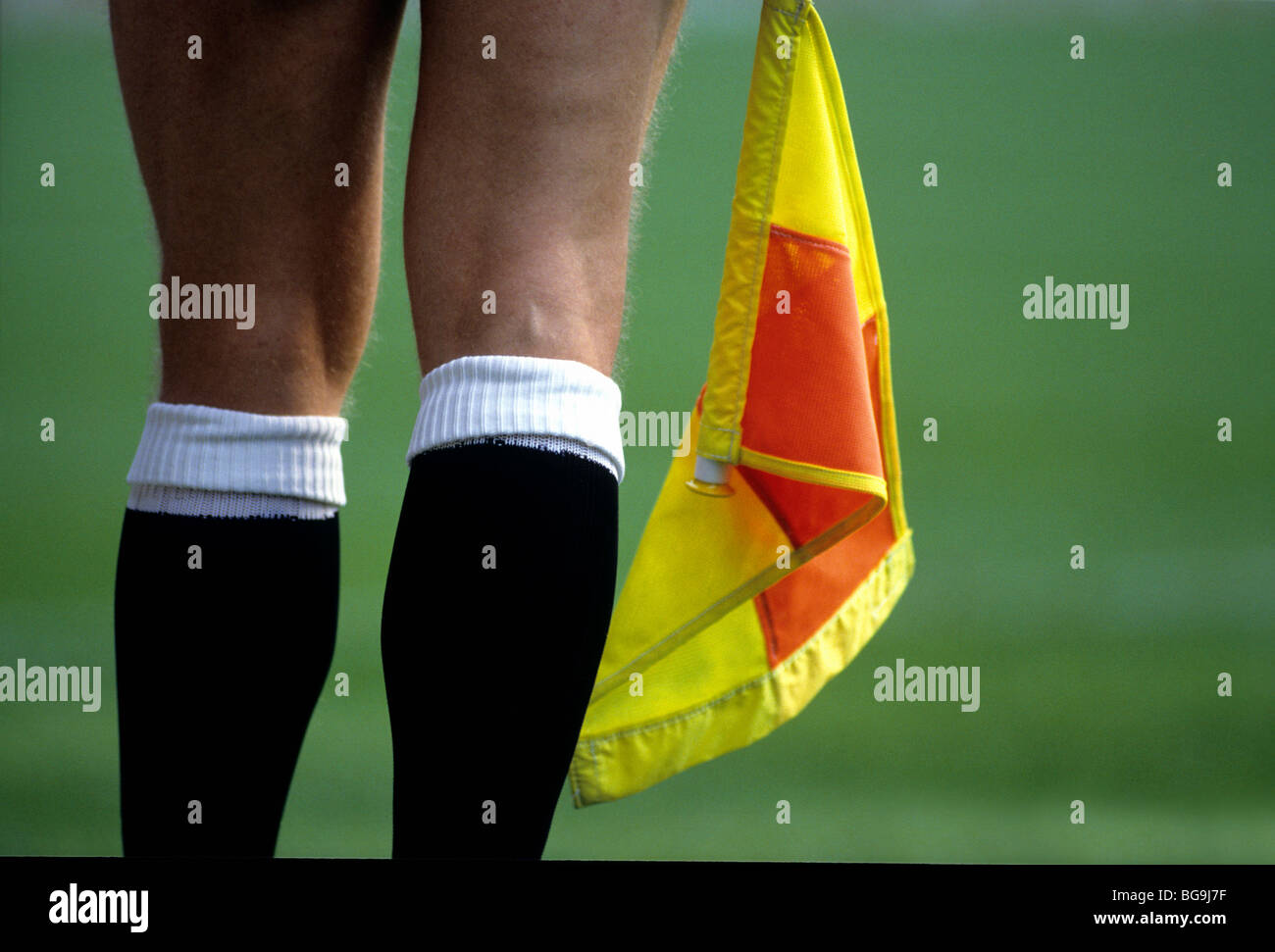 Football referee holding a flag Stock Photo - Alamy