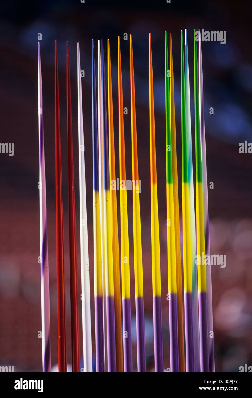Rack of javelins with spectators in background Stock Photo - Alamy