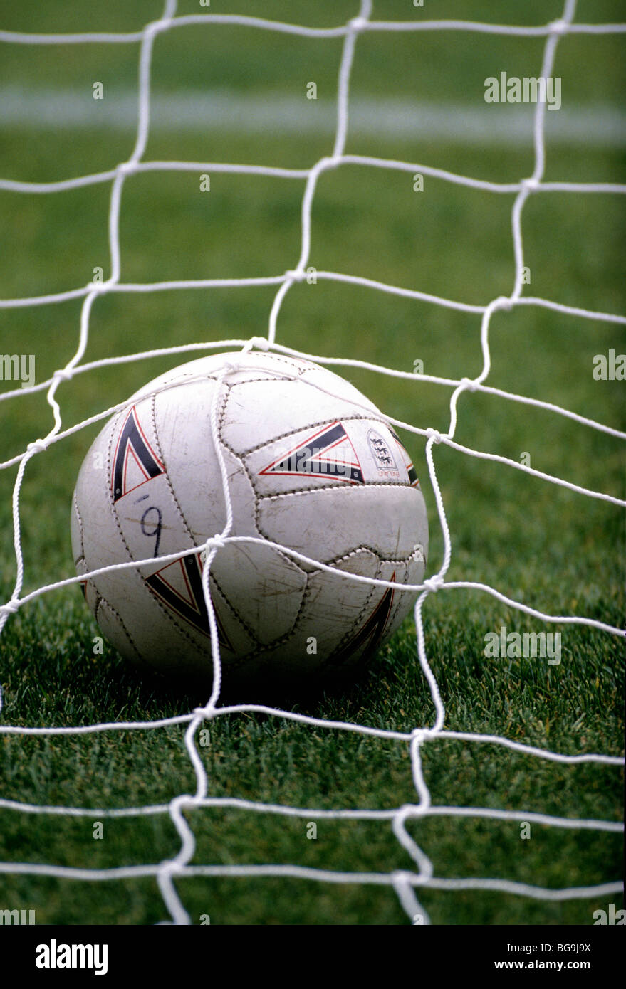 Football in the back of the net Stock Photo - Alamy