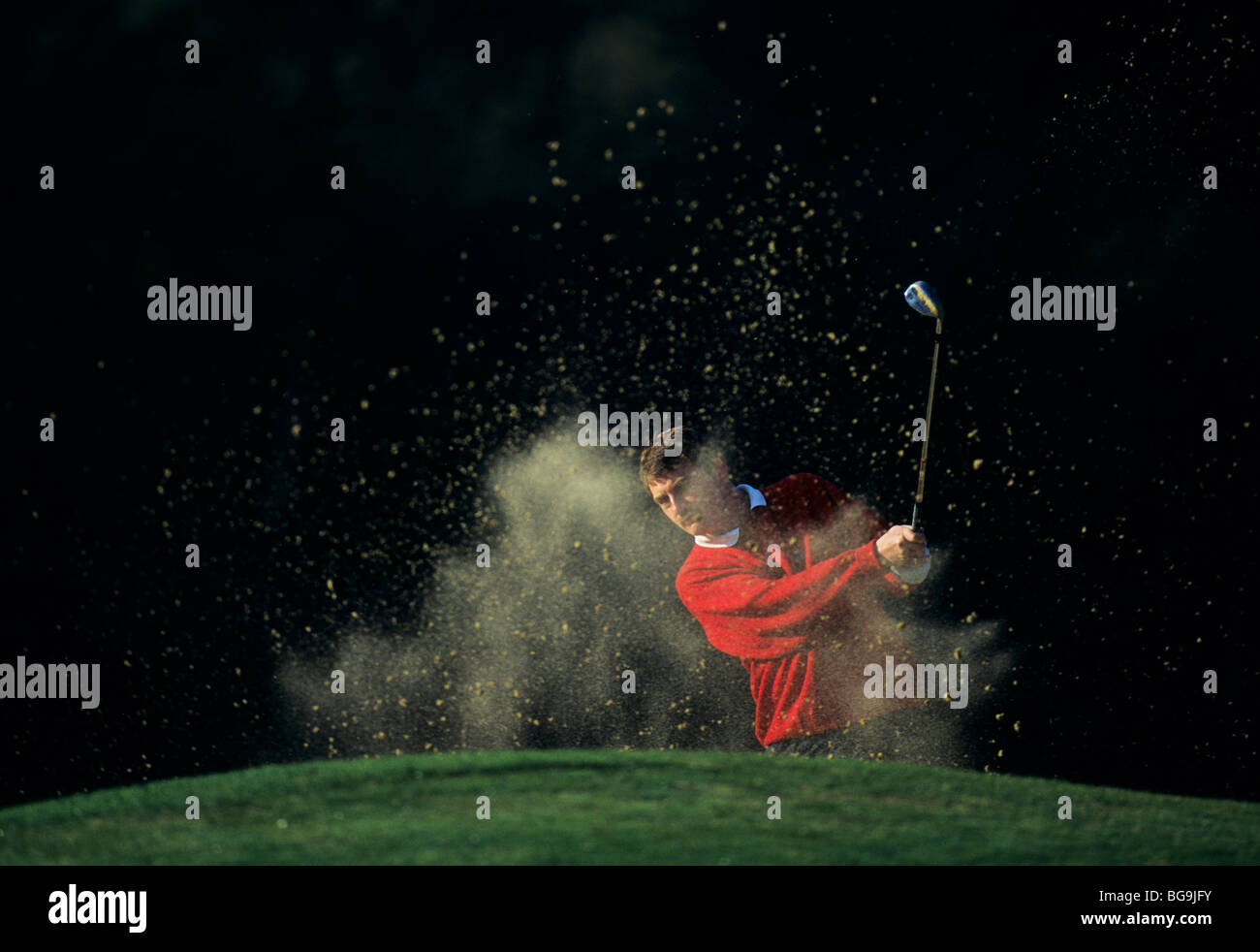 Golfer chips the ball out of the bunker Stock Photo - Alamy