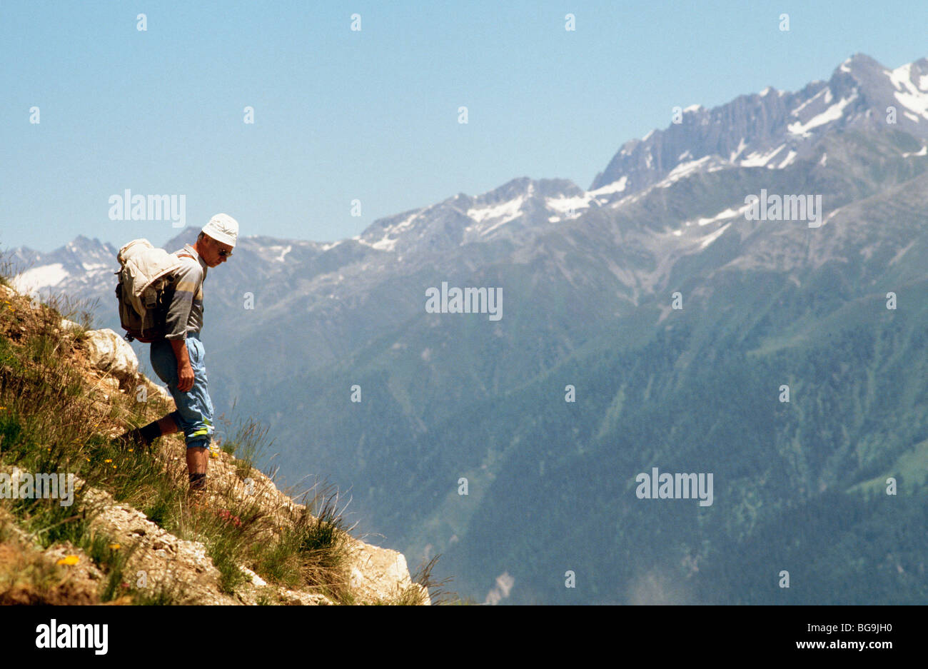 Hill walker walking along a the crest mountain Stock Photo - Alamy