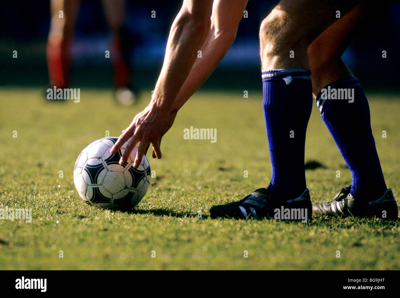Football player places the ball on the pitch Stock Photo - Alamy