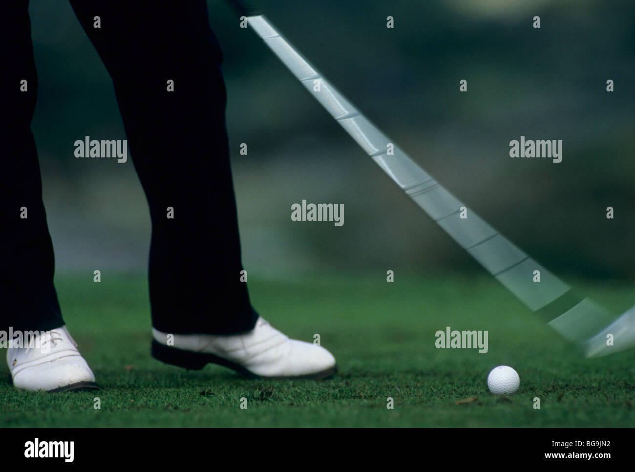 Action shot of a golfer striking a ball Stock Photo - Alamy