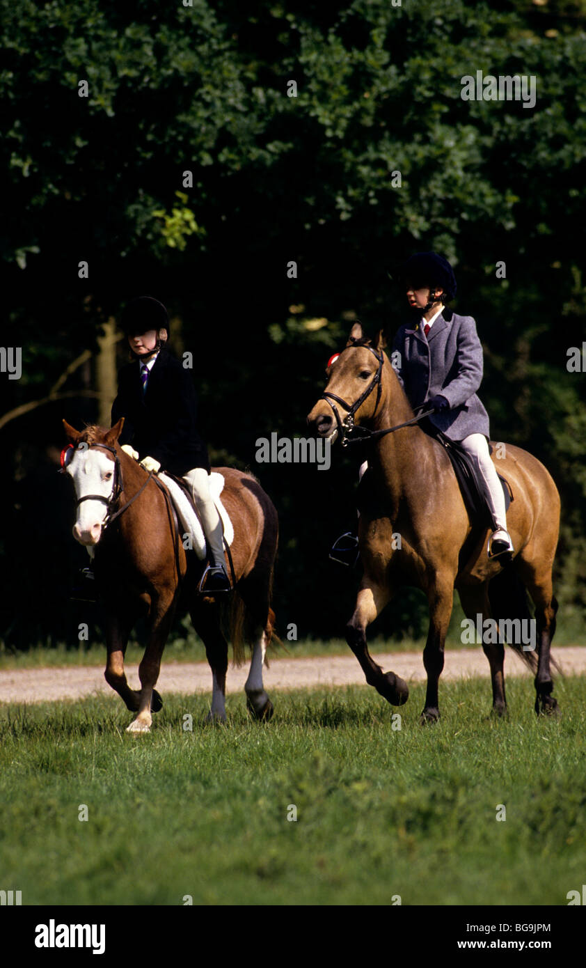 Two young horse riders on their horses Stock Photo - Alamy