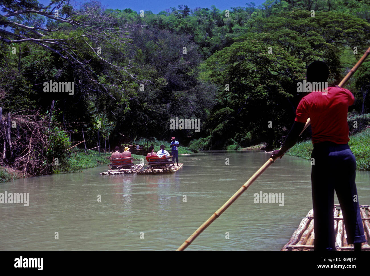 Jamaican man tourists bamboo raft hi-res stock photography and images ...