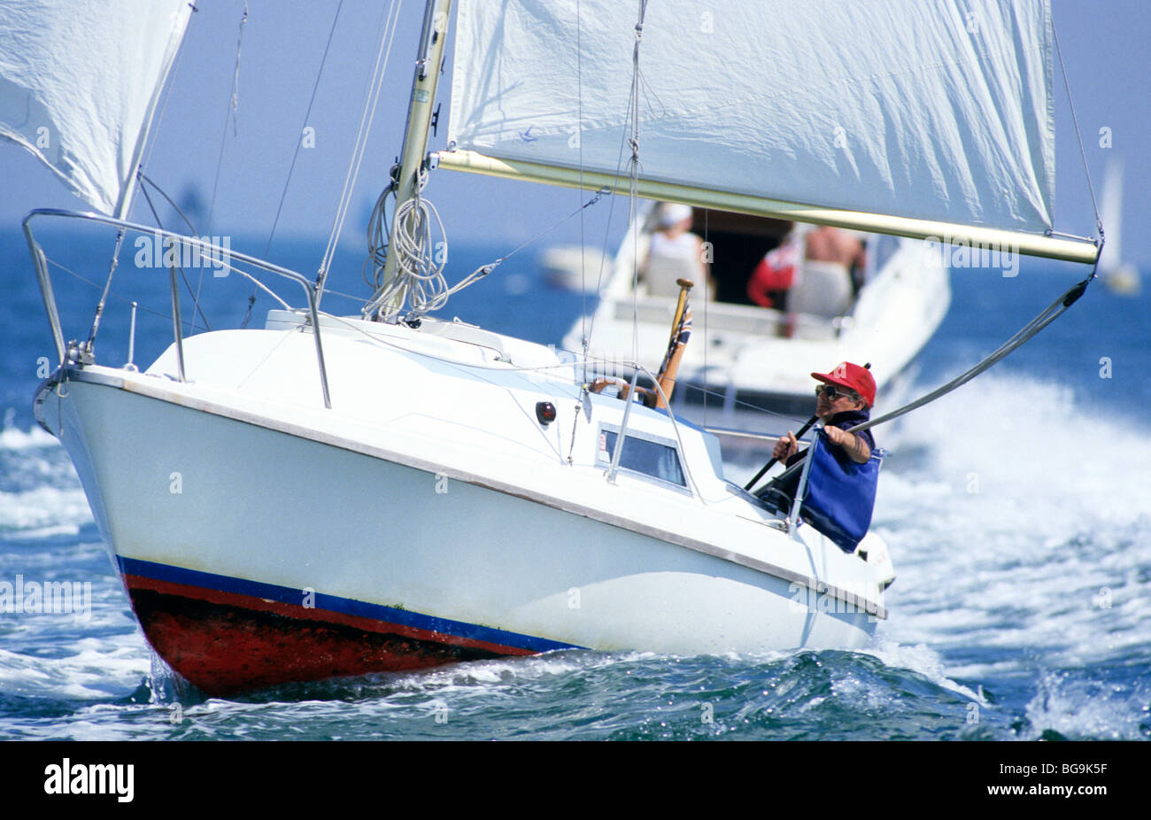Man enjoying time sailing on his boat Stock Photo - Alamy