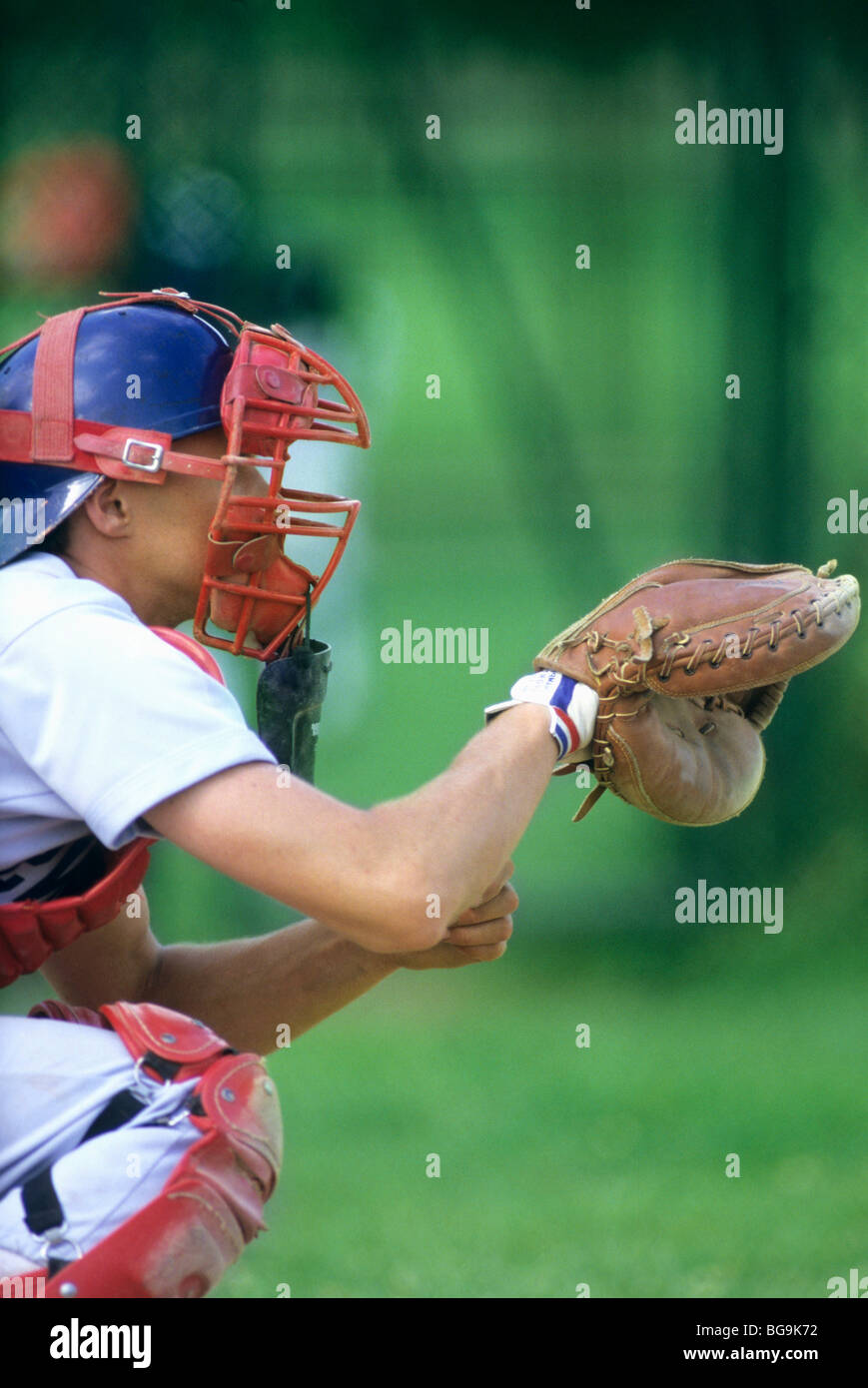 Baseball catcher wearing glove and face guard Stock Photo - Alamy