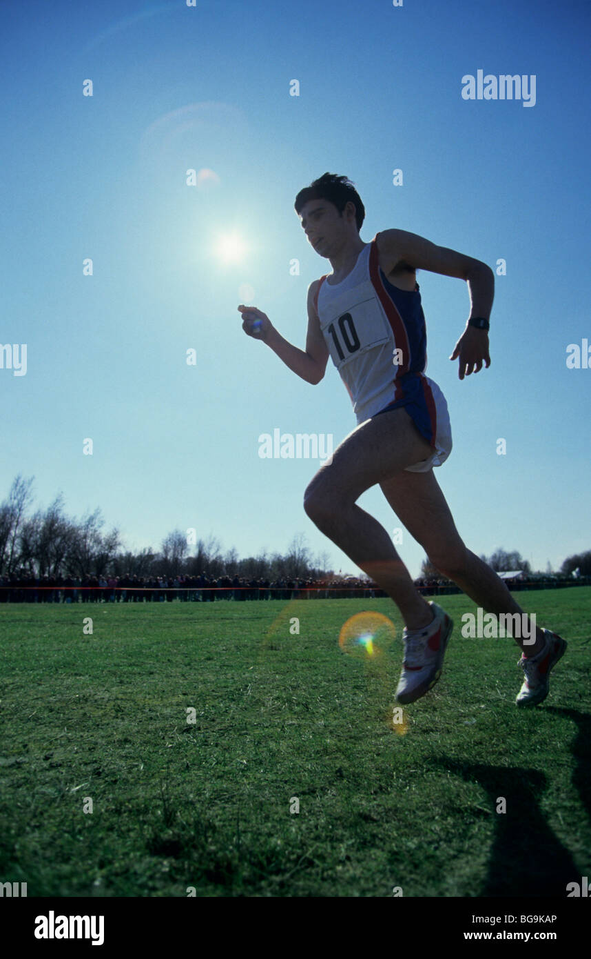 Man running across a field Stock Photo - Alamy