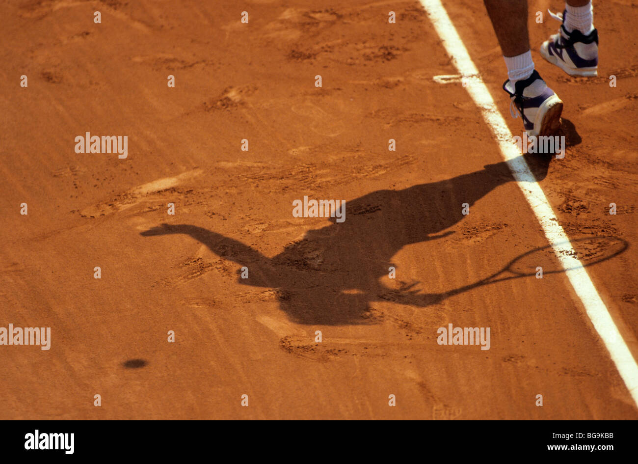 Tennis player serving on a clay court Stock Photo - Alamy