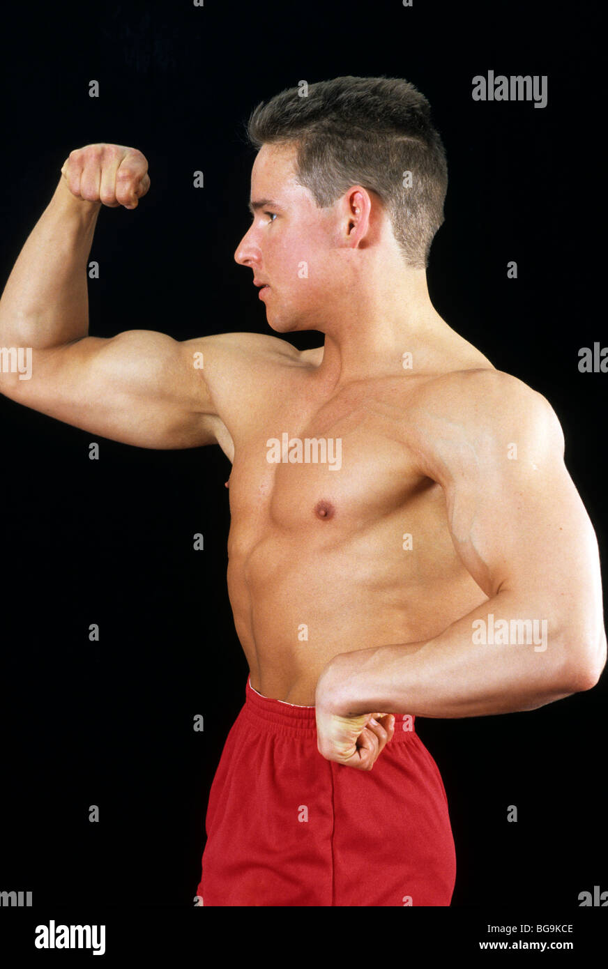 Body builder posing to show muscle definition Stock Photo - Alamy