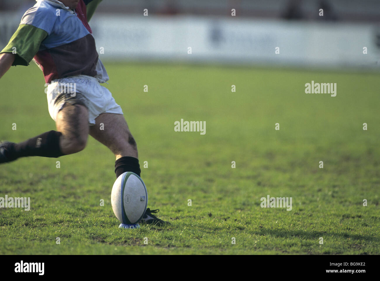 Rugby player kicks the ball off the tee Stock Photo - Alamy