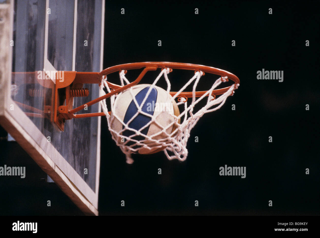 Basketball going through a hoop Stock Photo - Alamy