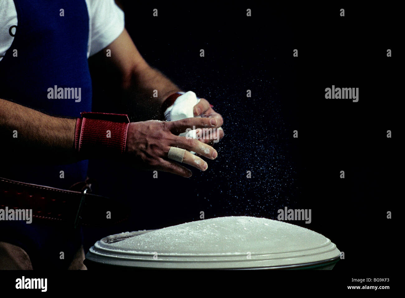 Weightlifter chalking his hands Stock Photo - Alamy