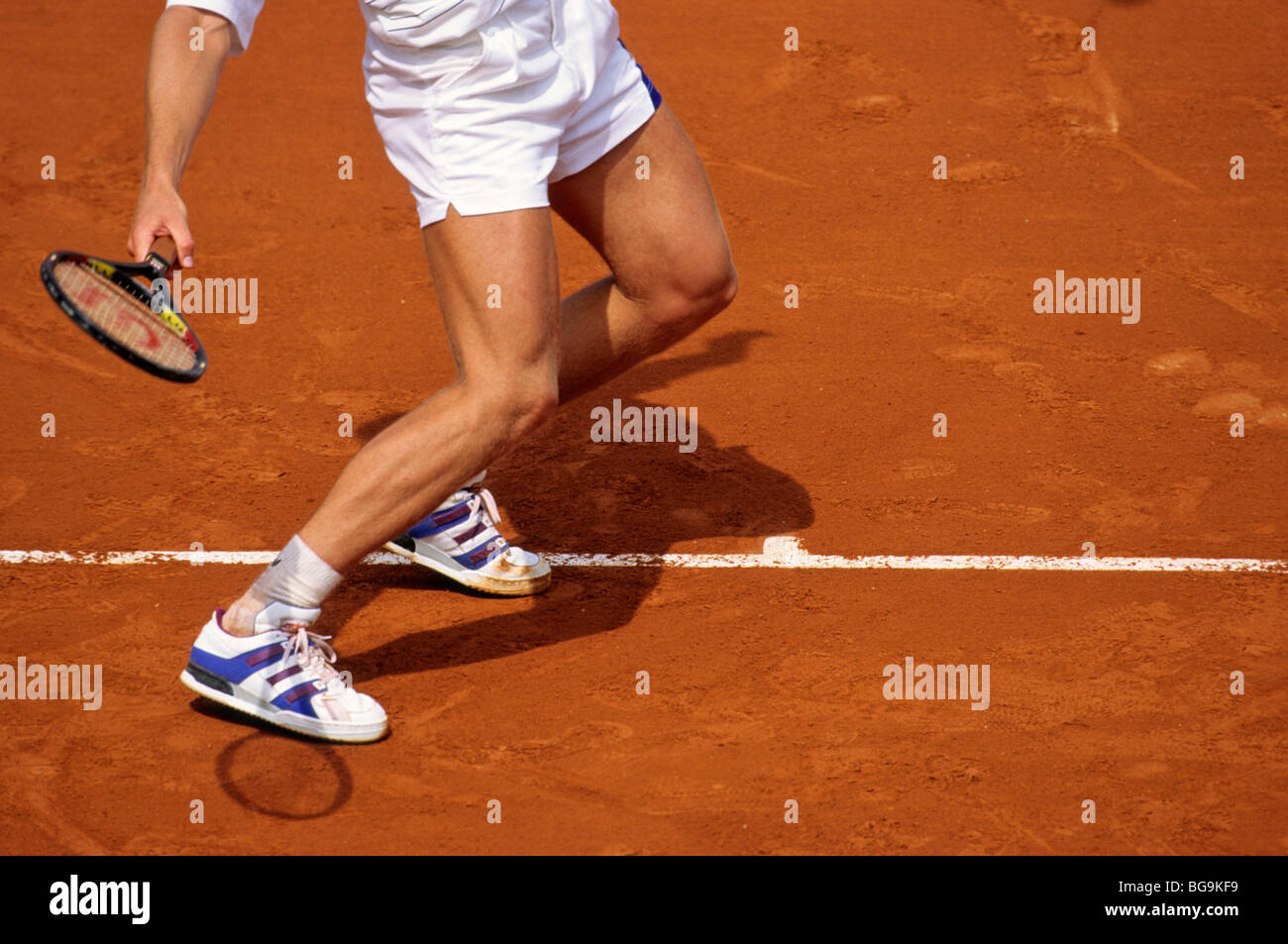 Tennis player on a clay tennis court Stock Photo - Alamy