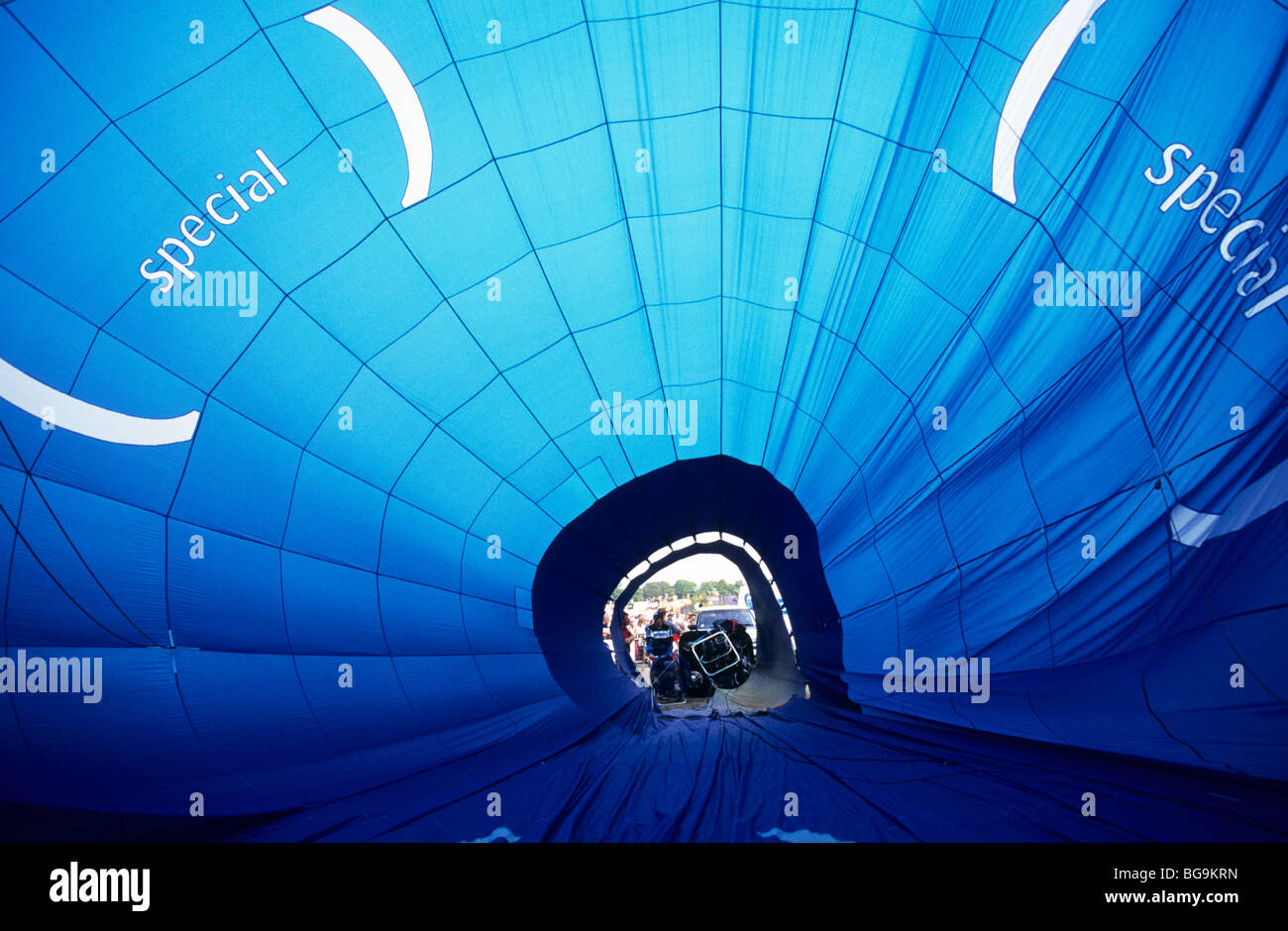 Crew member using a burner to inflate a hot air balloon Stock Photo - Alamy