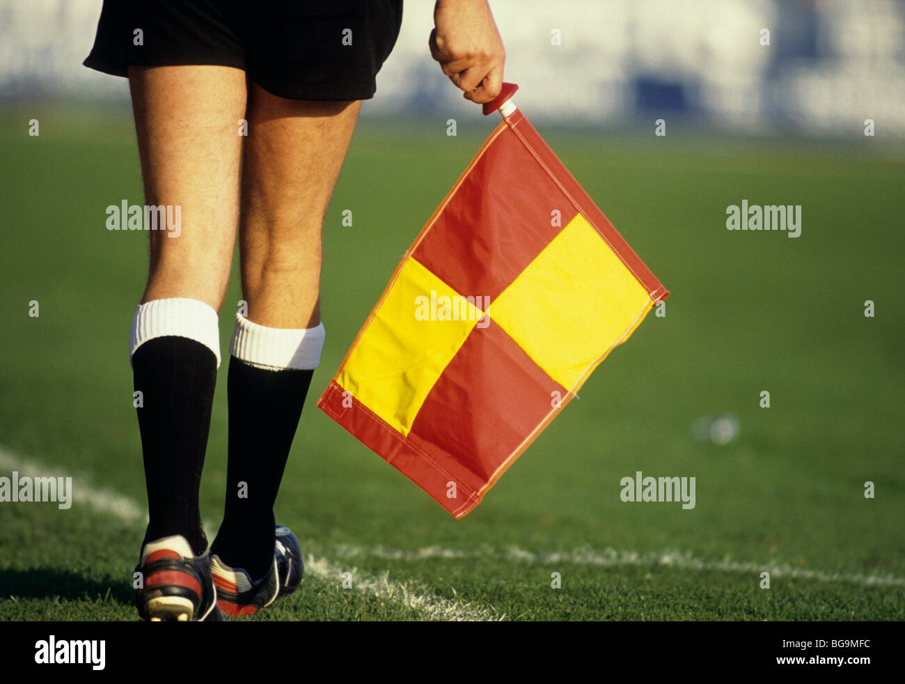 Football referee holding a flag Stock Photo - Alamy
