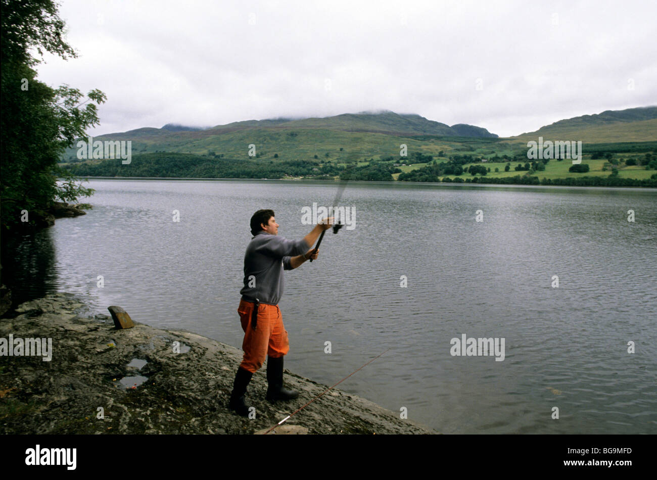 Man casting his fishing rod Stock Photo - Alamy