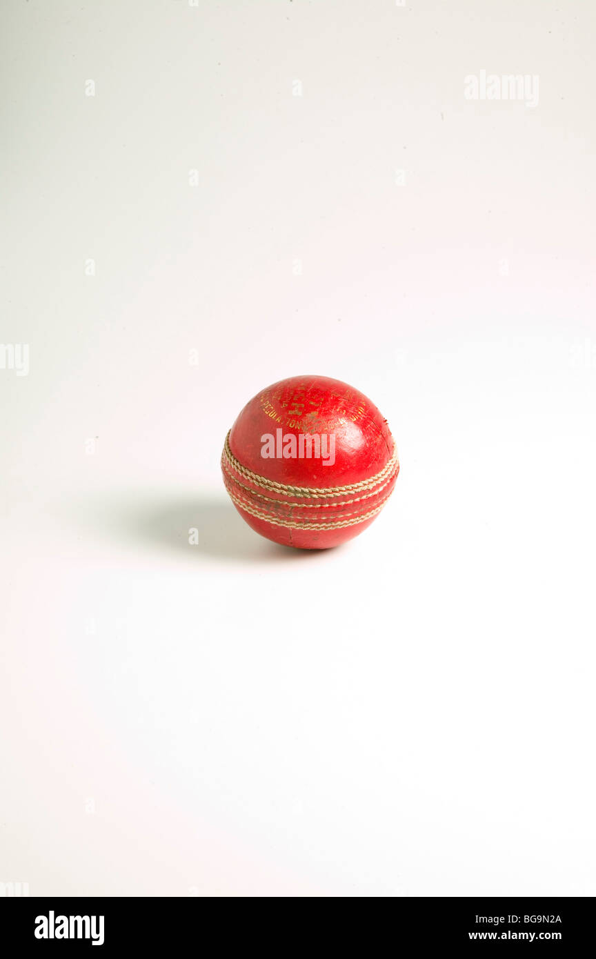 Bright red cricket ball Stock Photo - Alamy