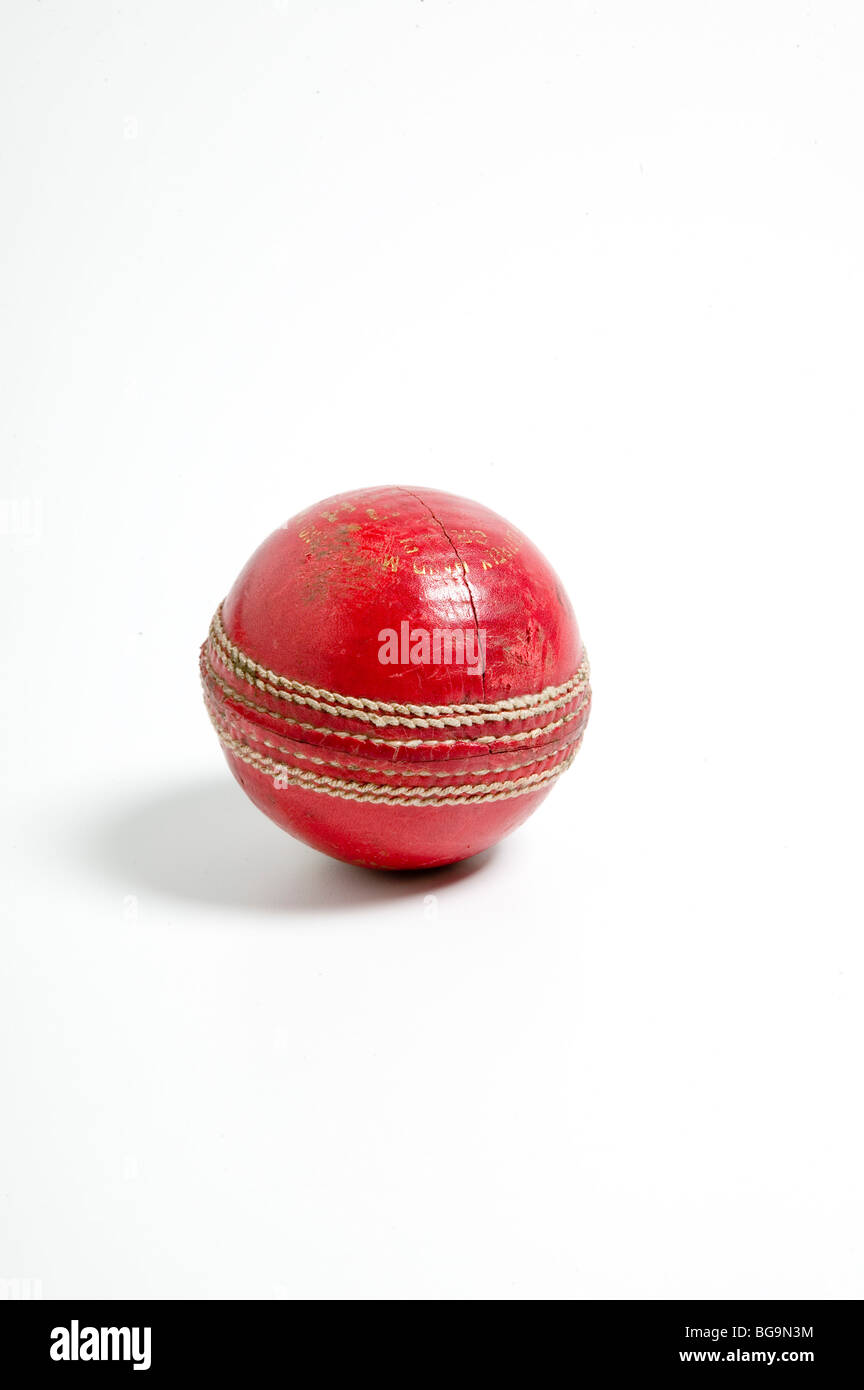 Bright red cricket ball Stock Photo - Alamy