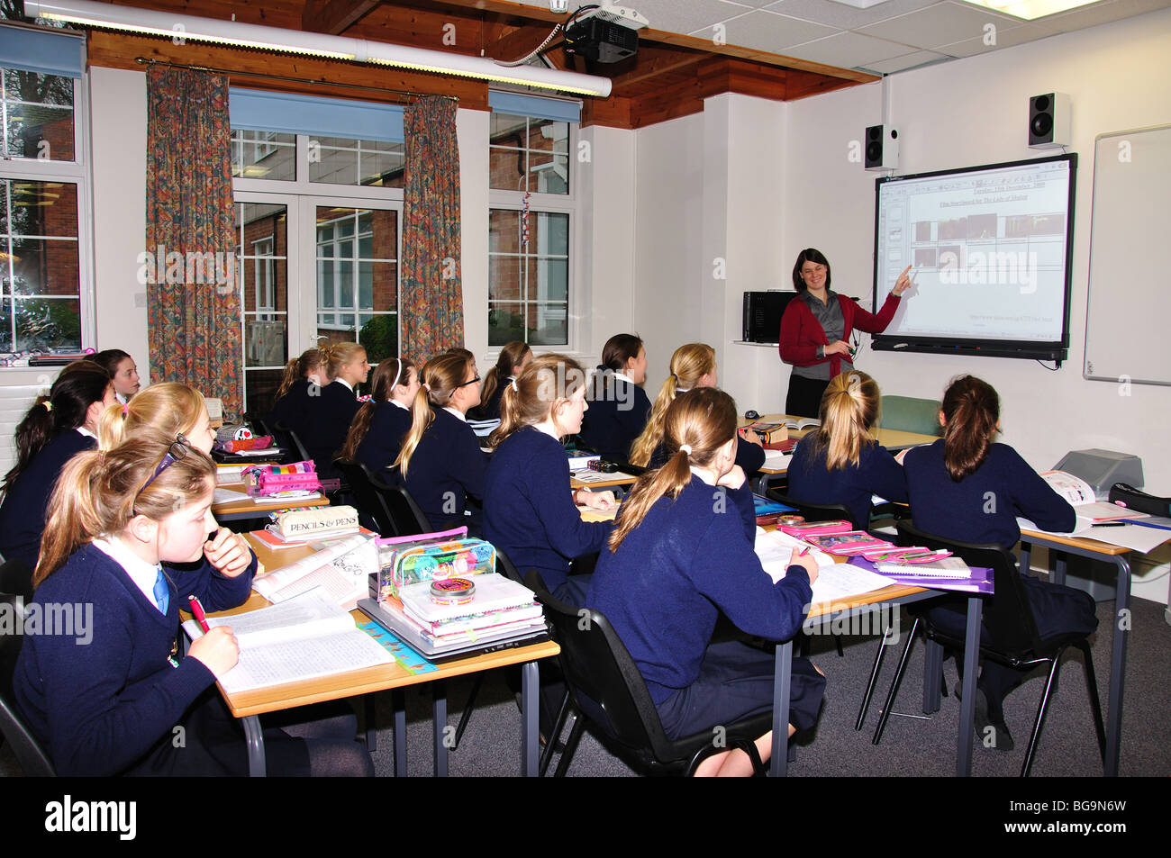 Female teacher teaching girls in classroom, Heathfield St Mary's School ...