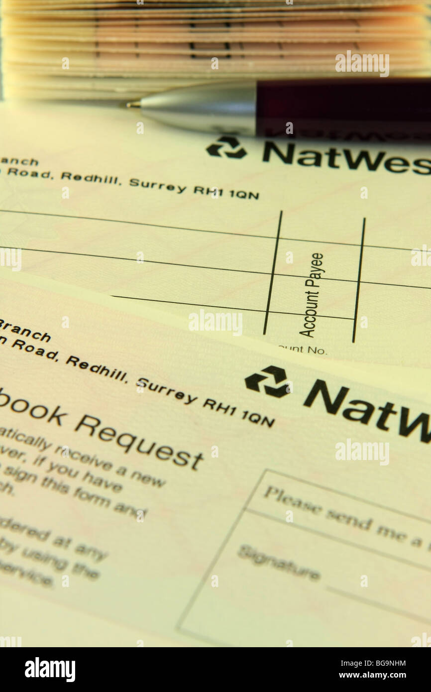 chequebook request form and blank cheque with biro and chequebook stubs ...