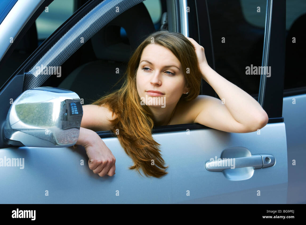 Happy young woman relaxing in the car Stock Photo - Alamy