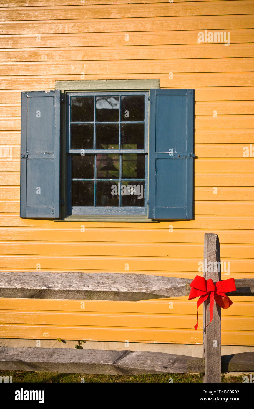 Yellow siding, green shuttered window, split rail log fence with red ...