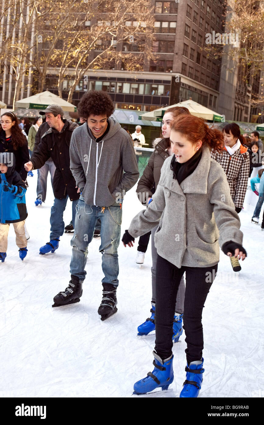 a trio of bright joshing happy teens, 2 girls & a boy, enjoy ice ...