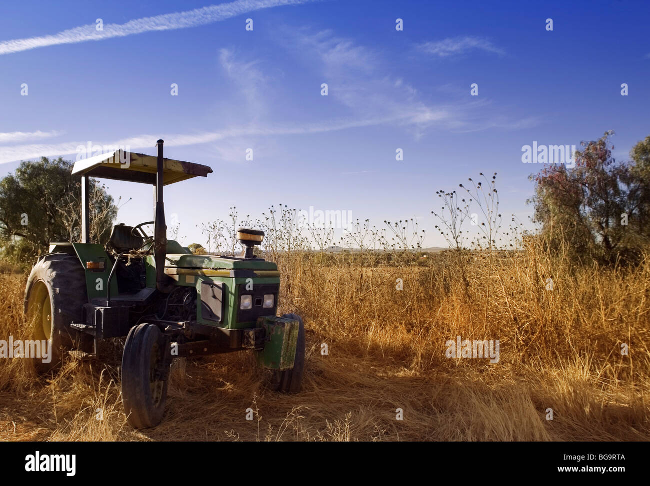 Tractor parked outside the crop field Stock Photo - Alamy