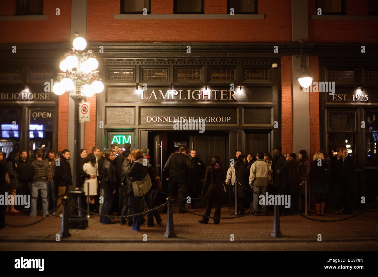 A crowd waiting in a queue outside the Lamplighter Public House in ...