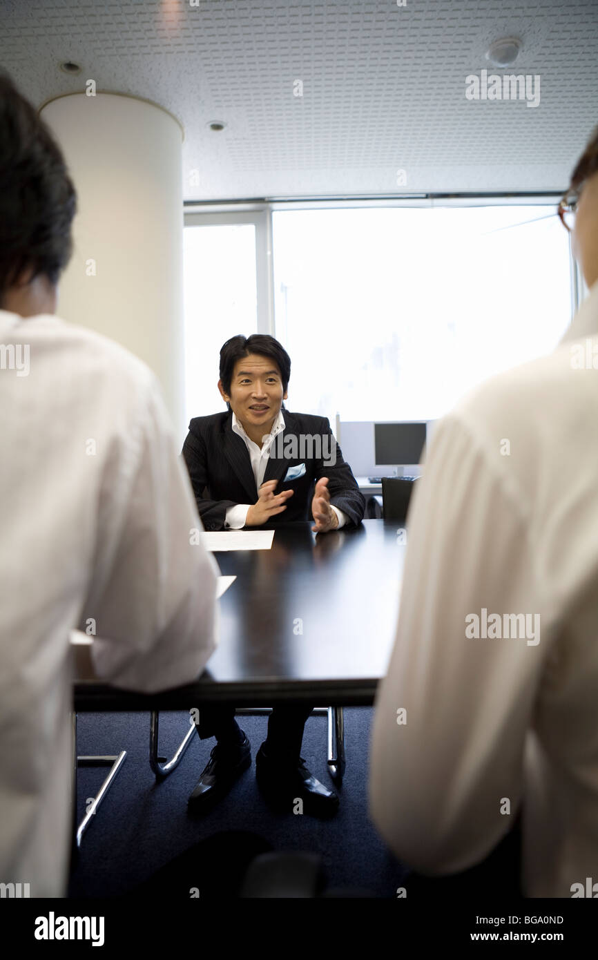 Three people meeting at table Stock Photo - Alamy