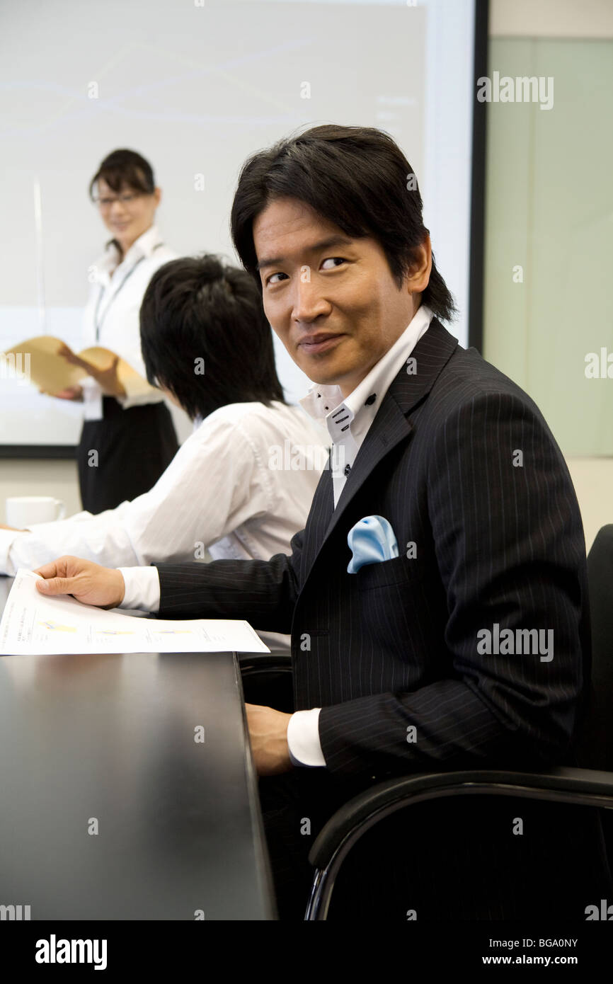 Three people meeting at table Stock Photo - Alamy